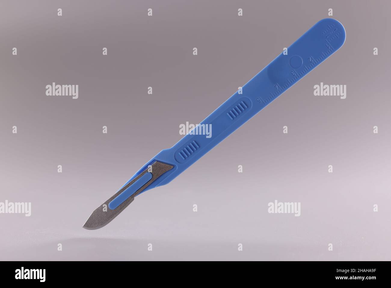 Medical scalpel with blue handle on gray background Stock Photo - Alamy
