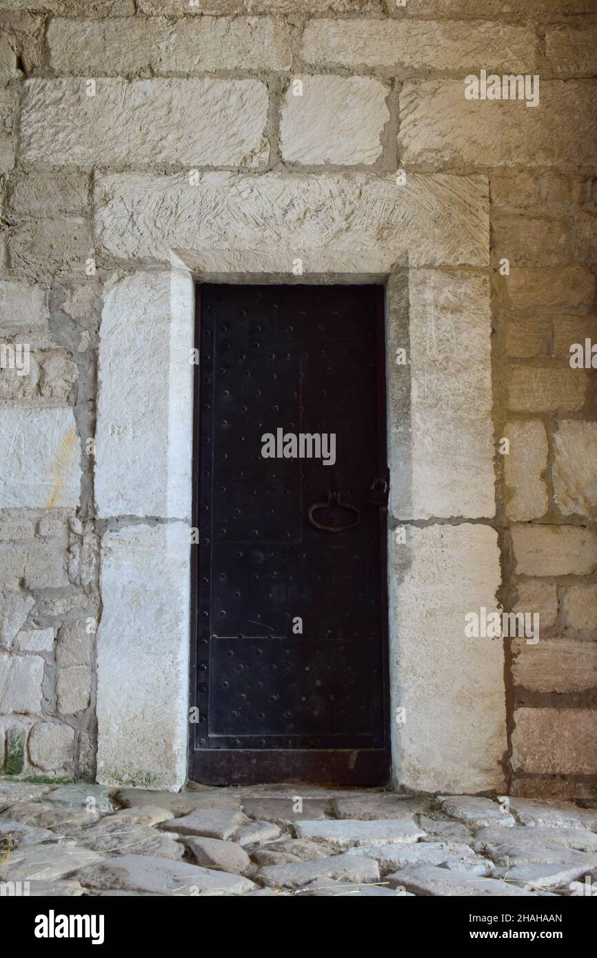 Wooden gates of an old medieval castle or fortress, covered with strips ...