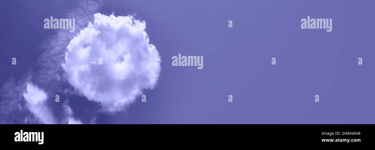 White round cloud shaped like donut on bright clean sky. Wide banner ...