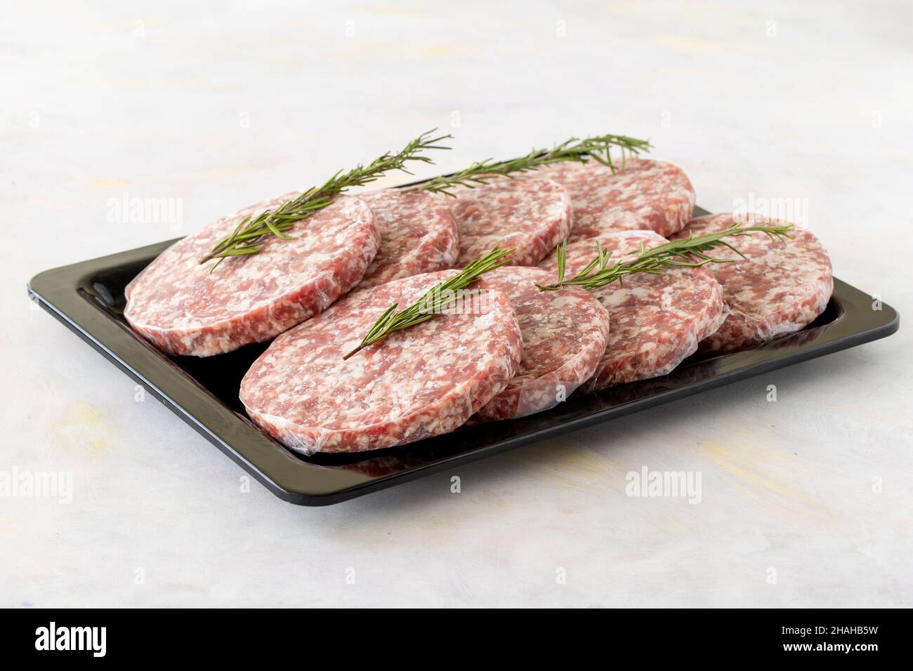 packaged raw beef burger meat on white wooden background. Meat ...