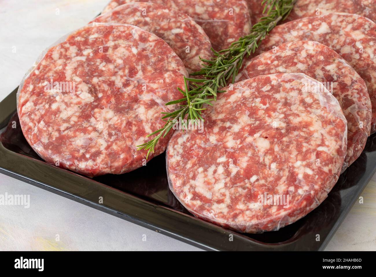 packaged raw beef burger meat on white wooden background. Meat ...