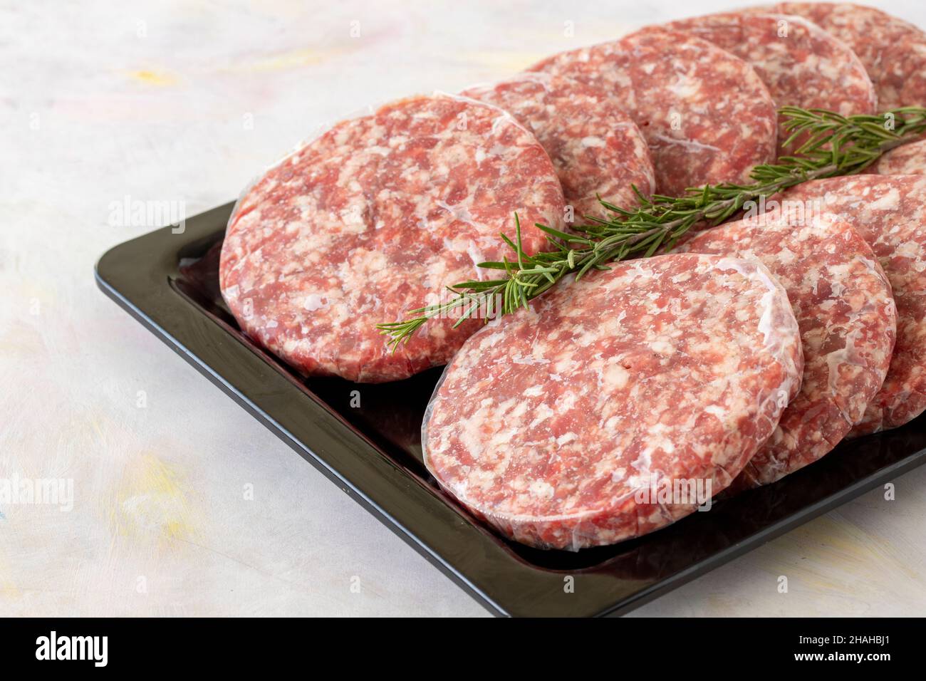 packaged raw beef burger meat on white wooden background. Meat ...