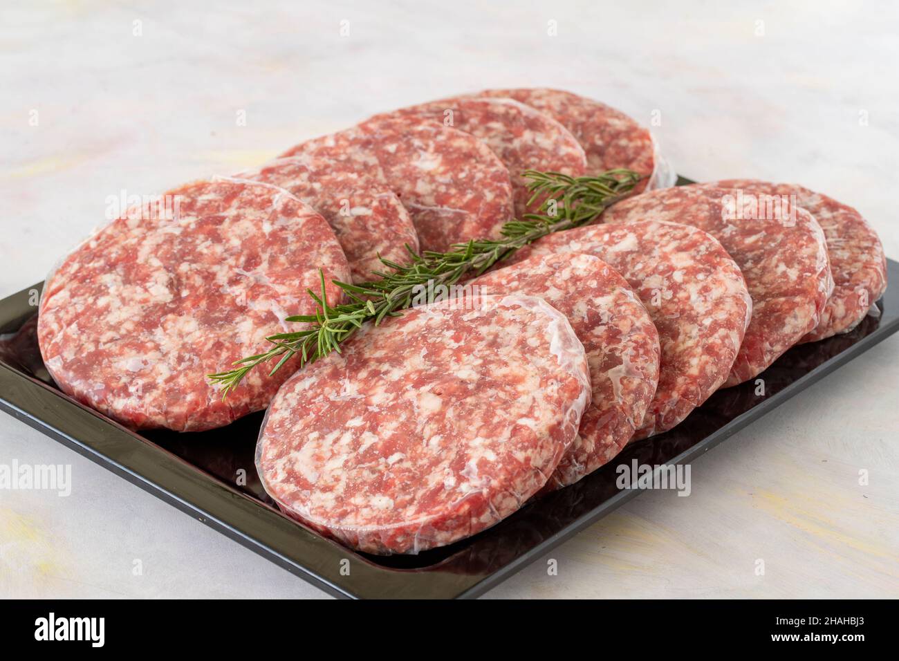 packaged raw beef burger meat on white wooden background. Meat ...
