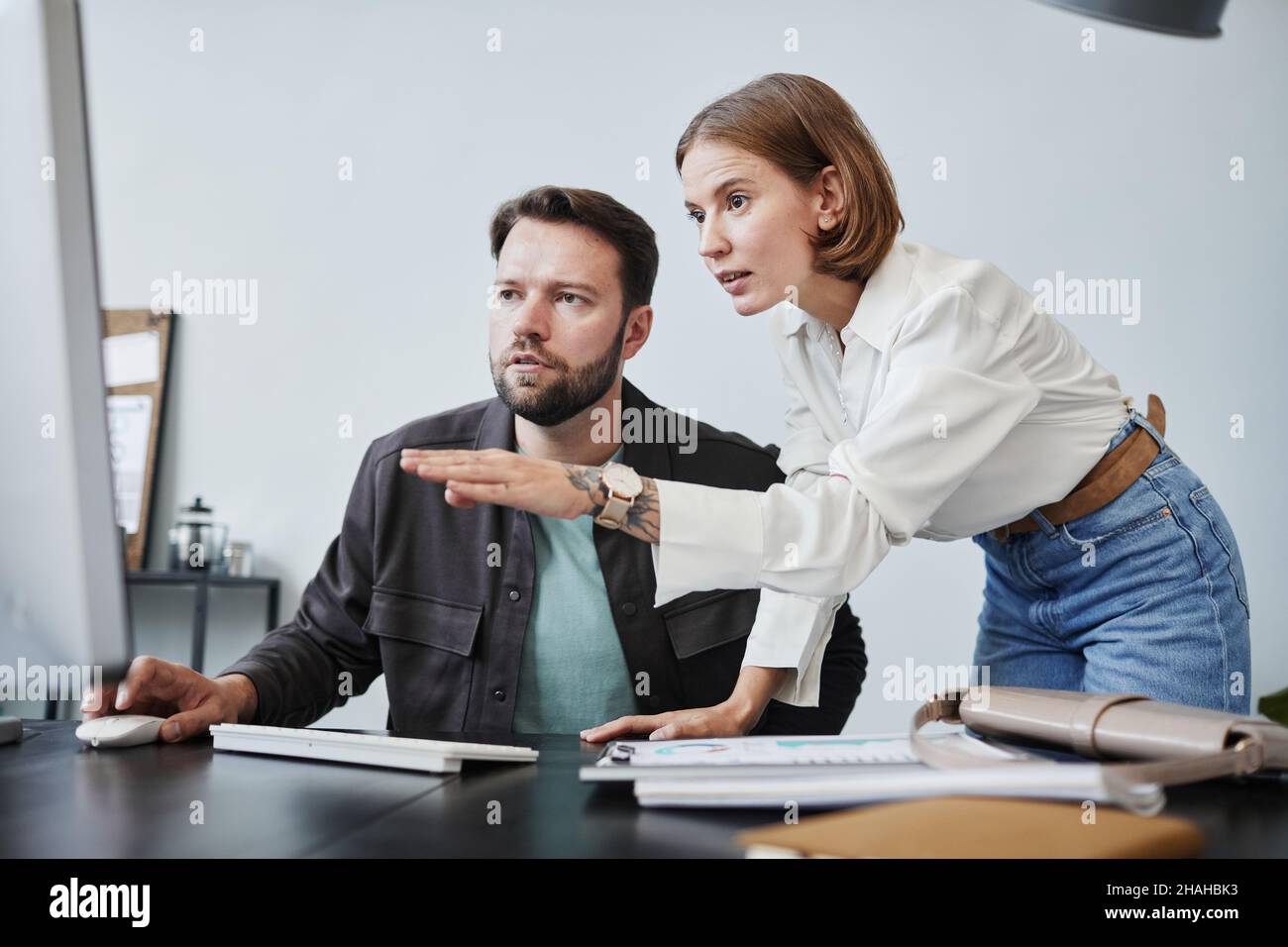 Business people pointing at monitor hi-res stock photography and images ...