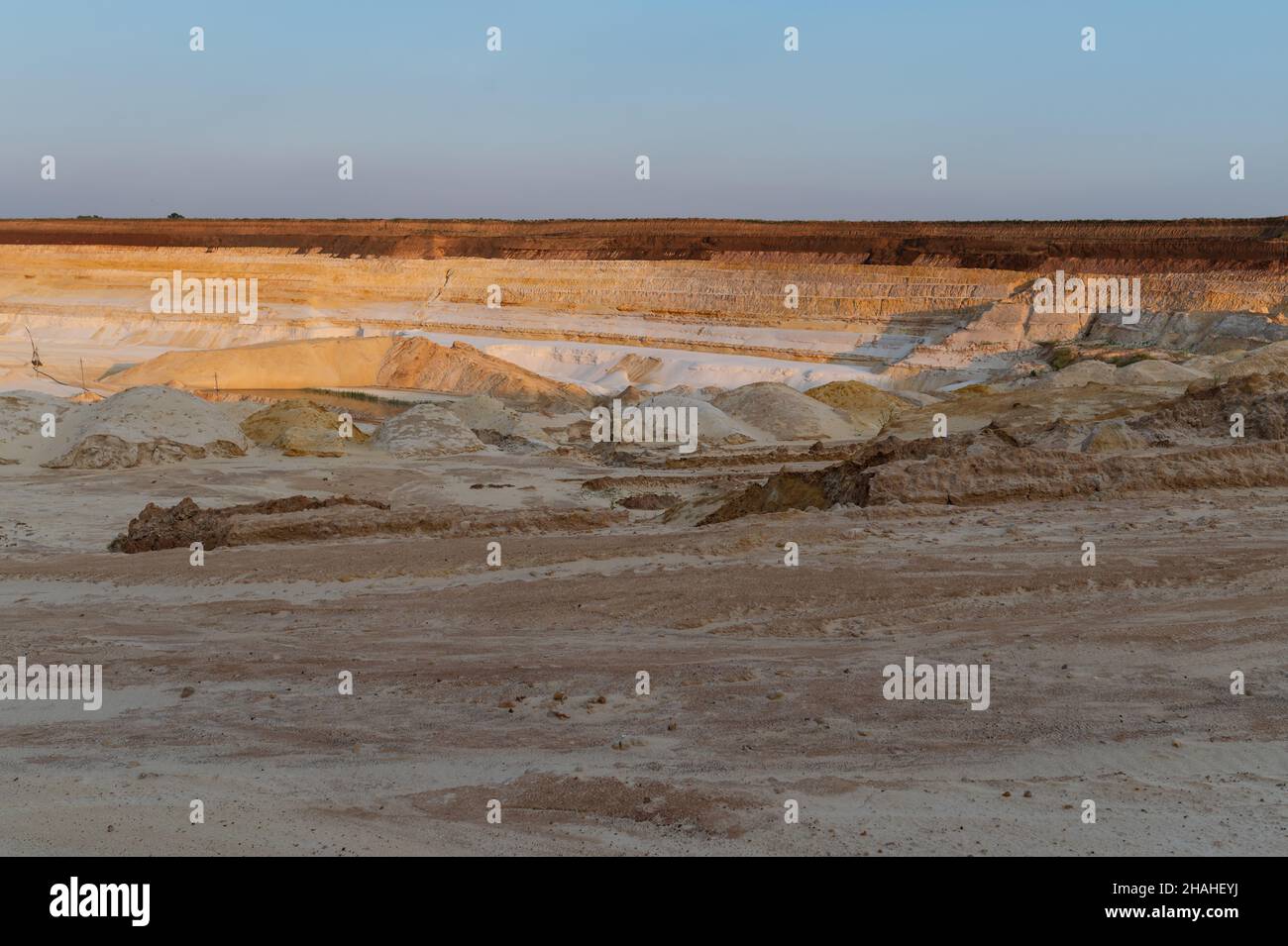 Sand quarry. Turquoise lagoon and surface mine with exposed colored ...