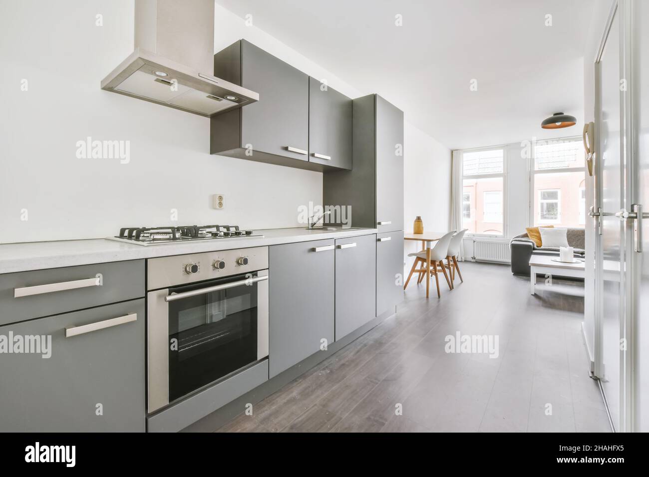 Elegant and cozy kitchen with gray kitchen unit Stock Photo - Alamy
