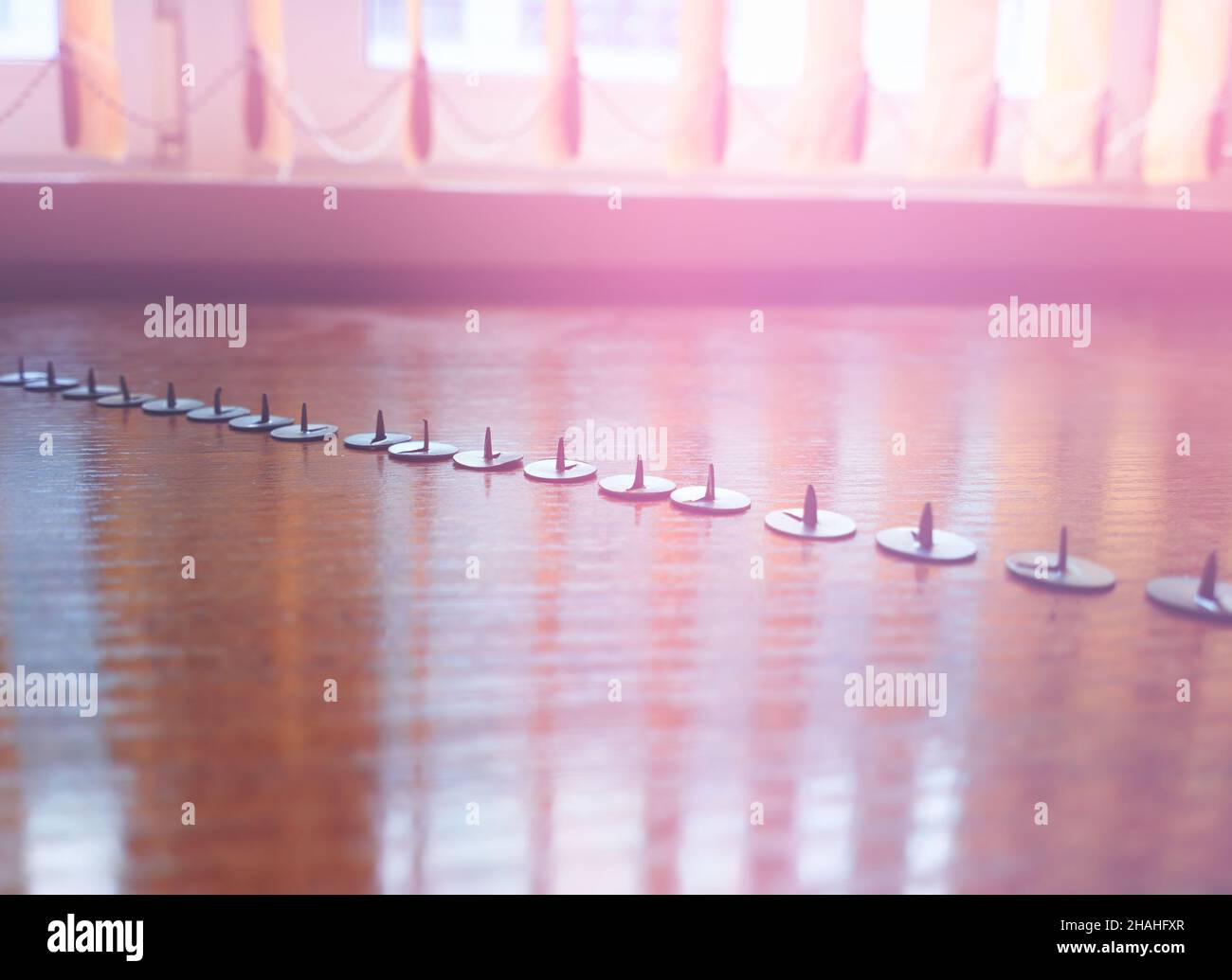 Diagonal office pins on the table bokeh backdrop Stock Photo - Alamy