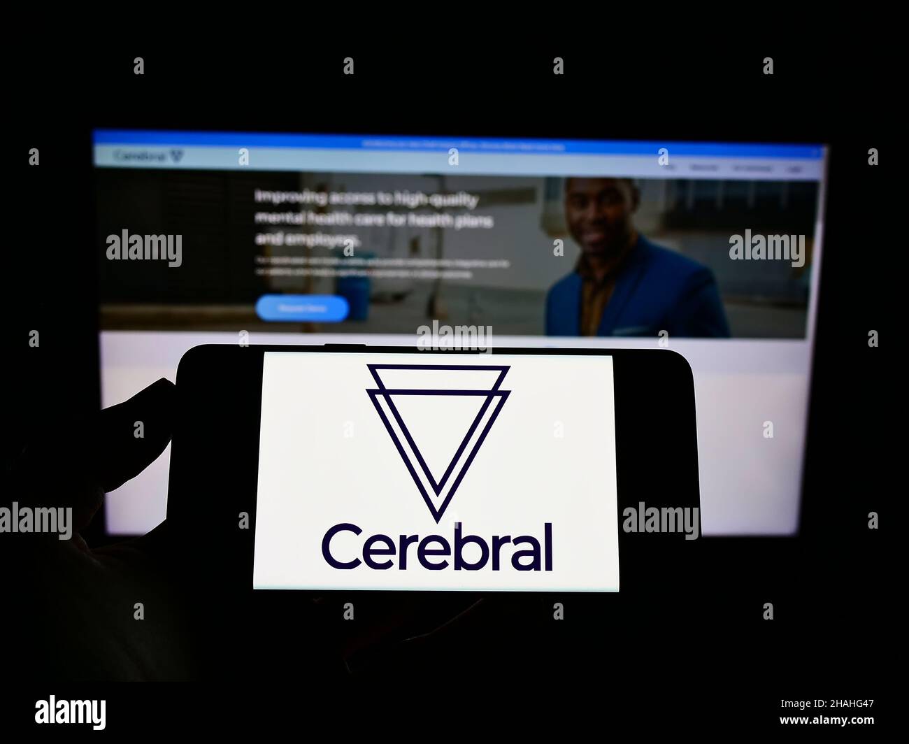 Person holding cellphone with logo of American mental health company ...