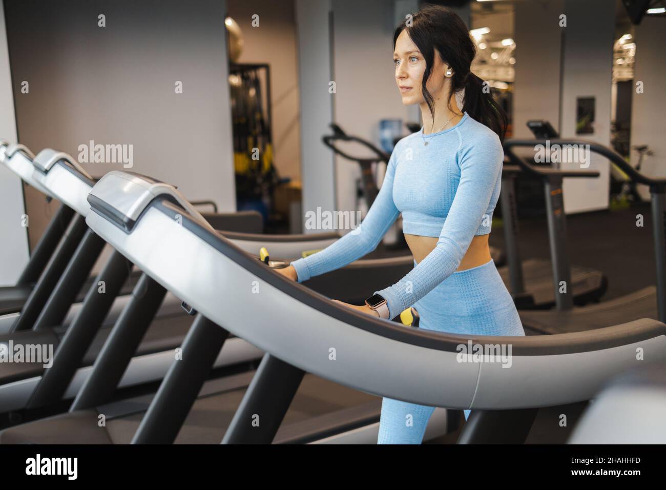 Fitness woman walking on a treadmill Stock Photo - Alamy