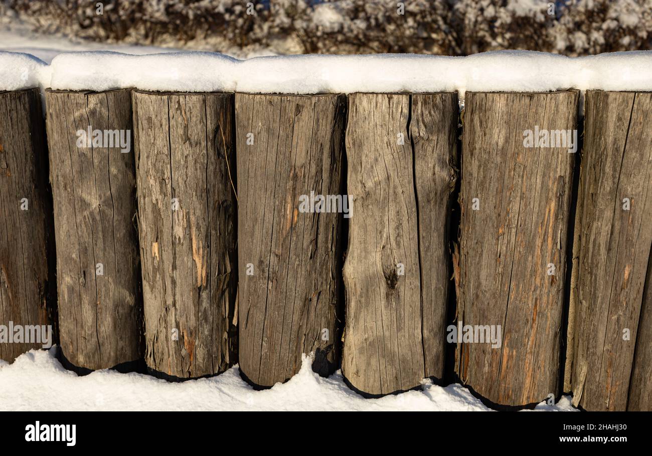 a fence made of vertical logs covered with snow. High quality photo ...
