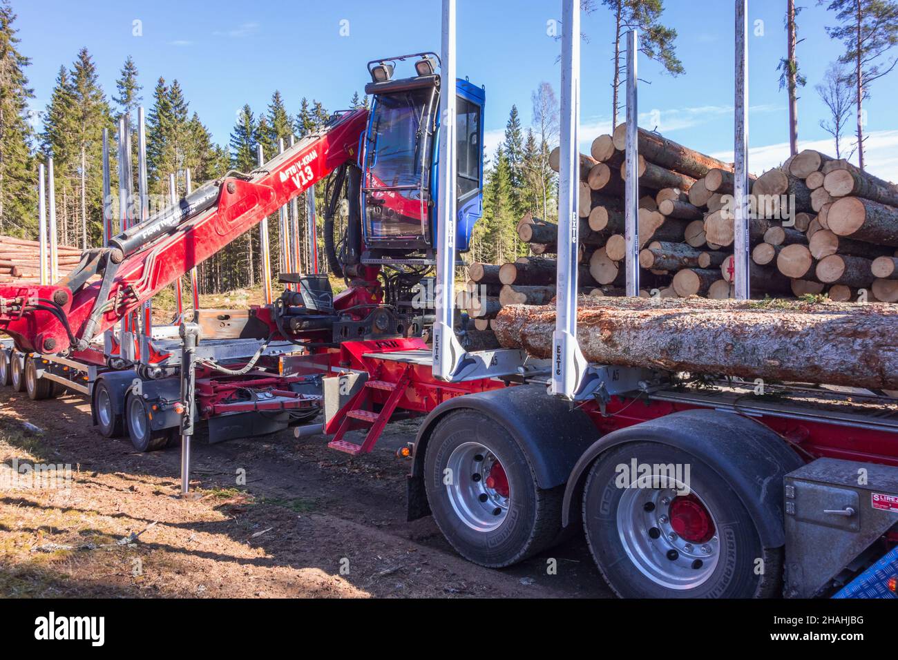 Timber truck with trailer and a crane Stock Photo - Alamy