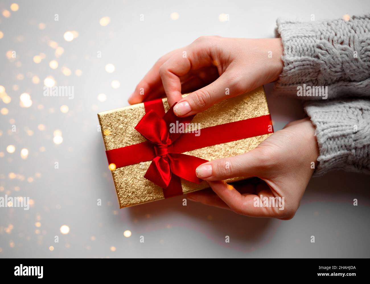 hands hold a gift on a white background Stock Photo - Alamy