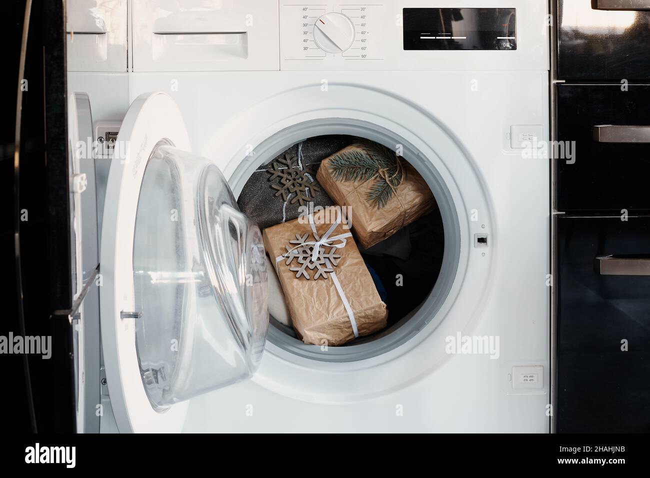 Christmas gifts in the washing machine. Christmas Stock Photo - Alamy