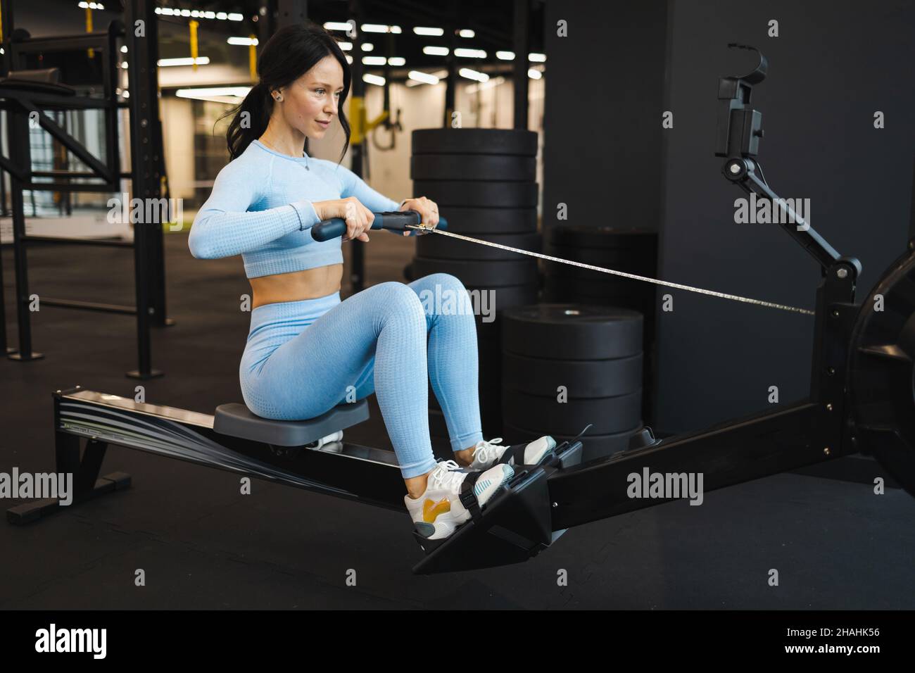 Woman doing exercise on rowing hi-res stock photography and images - Alamy