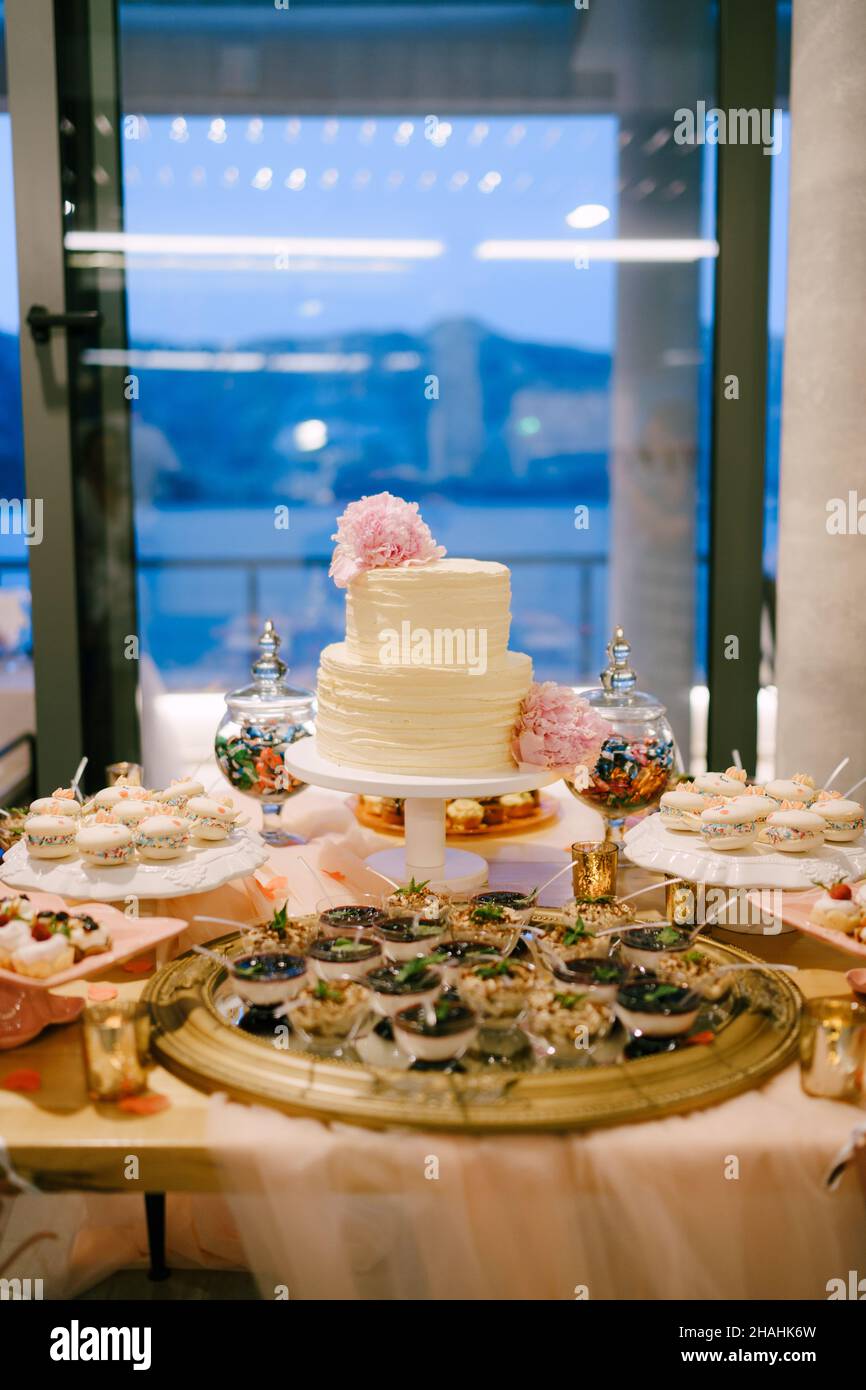 Wedding set table with bunk cake, pastries and sweets Stock Photo - Alamy