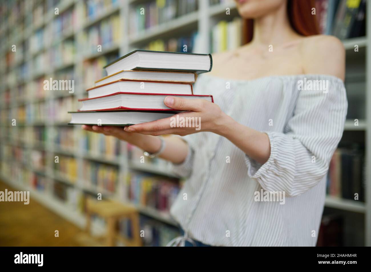 Woman hands holding a stack of books Stock Photo - Alamy