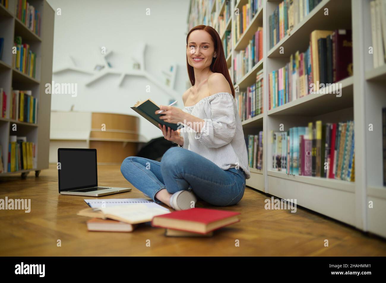 Woman reading book on library floor hi-res stock photography and images ...