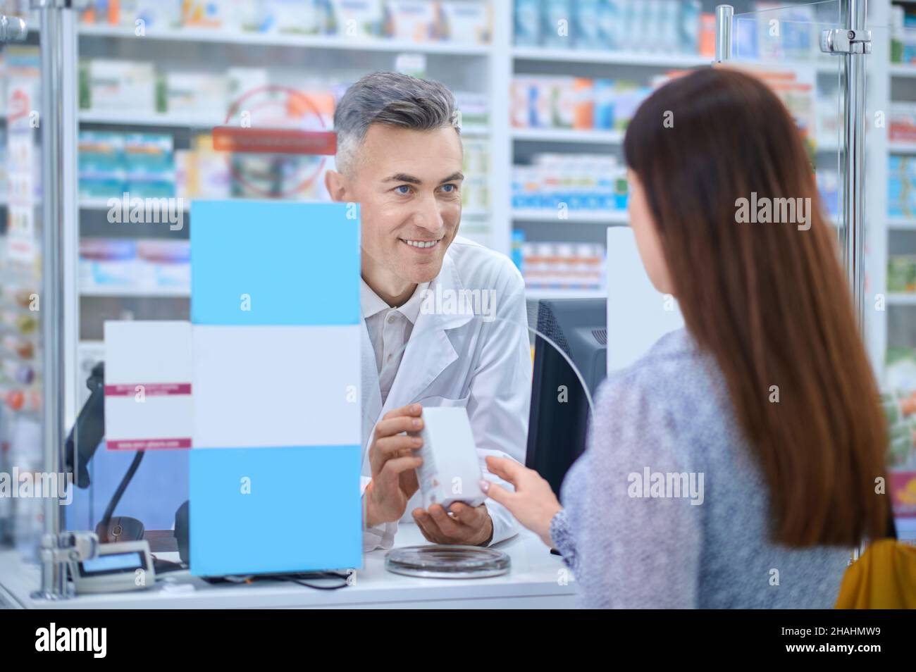 Female client standing near the pharmacy counter Stock Photo - Alamy