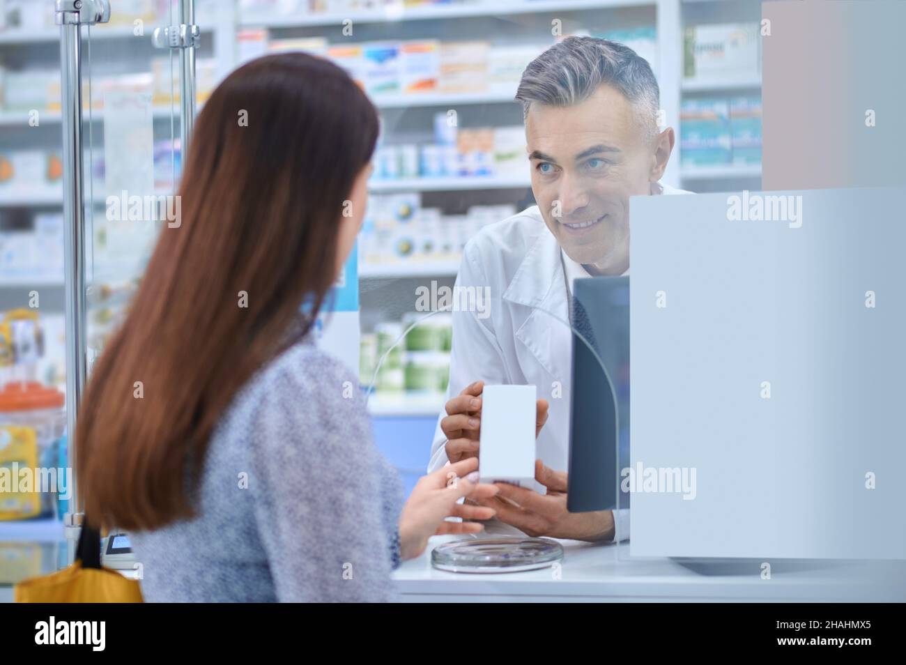 Female client standing near the pharmacy counter Stock Photo - Alamy