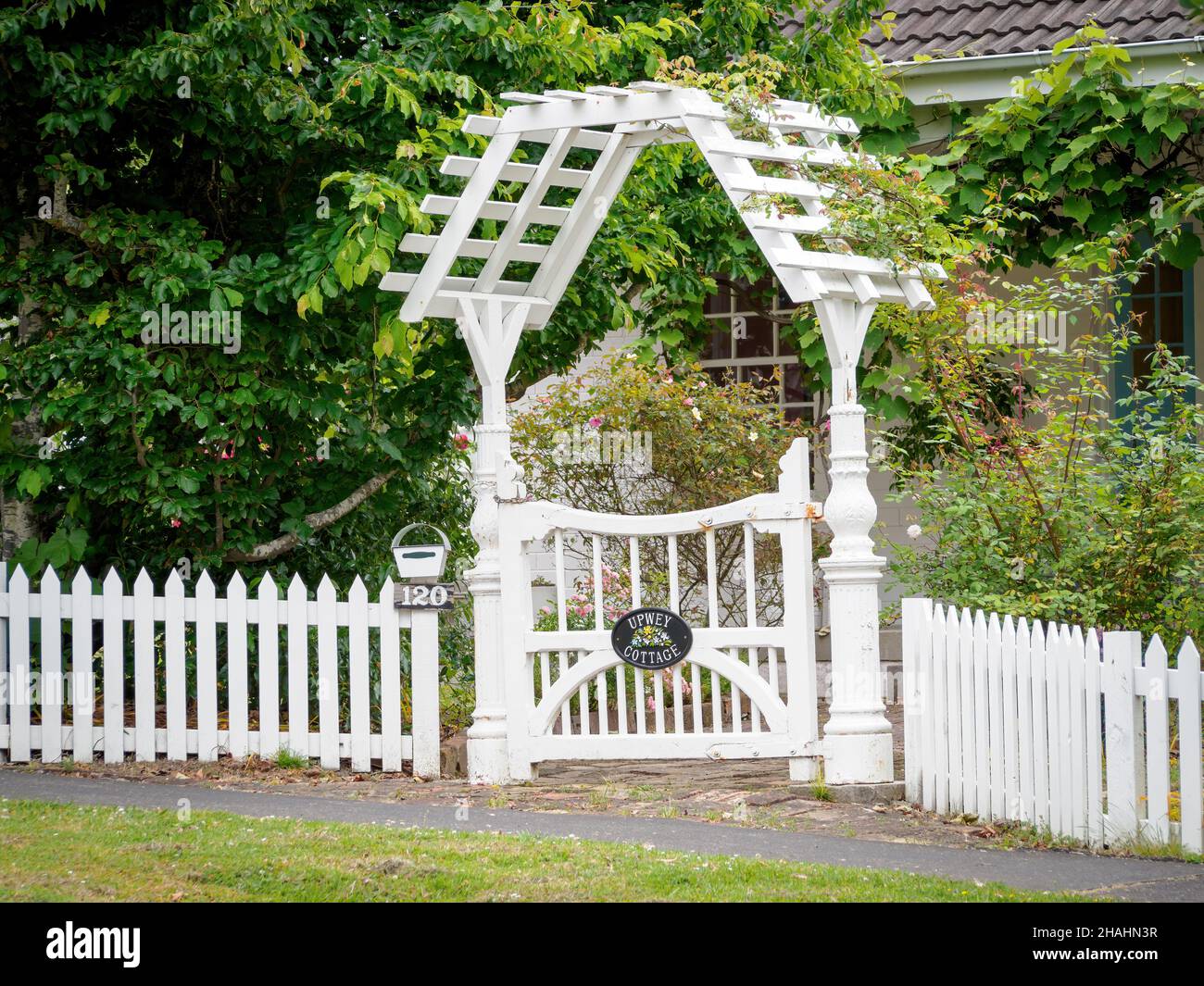 AUCKLAND, NEW ZEALAND - Dec 01, 2021: View of white wooden garden gate ...