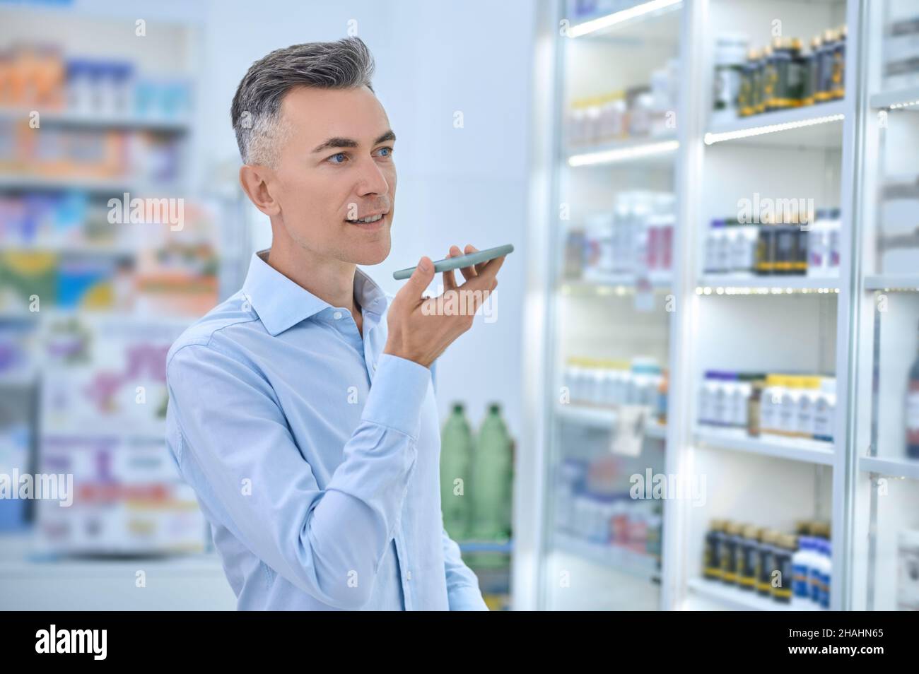 A man choosing medicines in a drugstore Stock Photo - Alamy