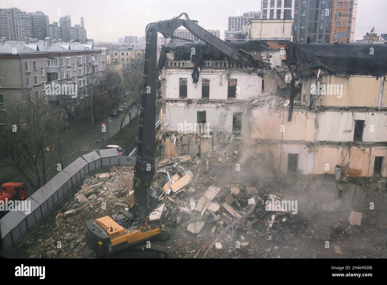 Construction equipment destroys a house on the site. Dismantling and ...