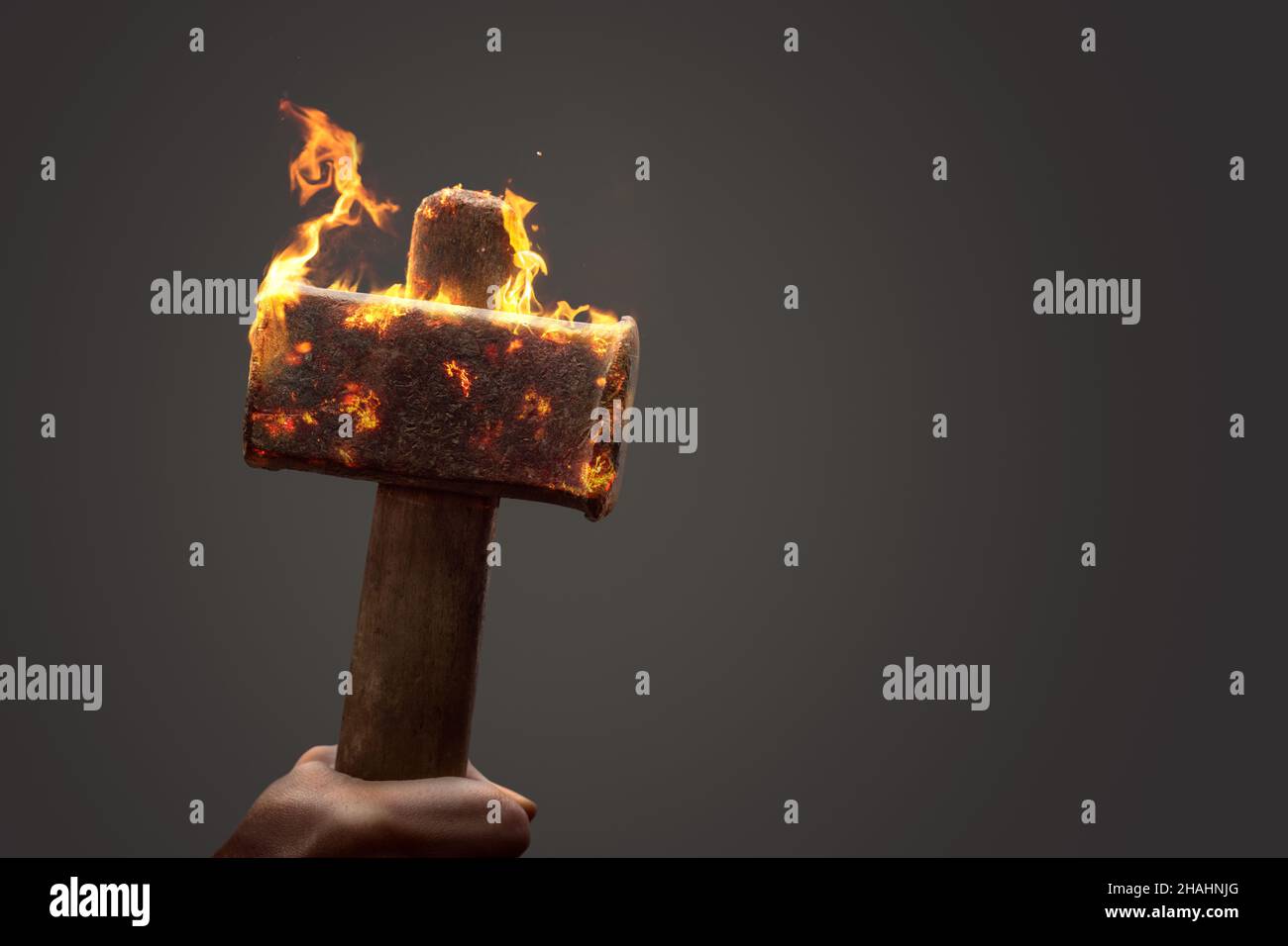 Old iron hammer on fire with copy space Stock Photo - Alamy