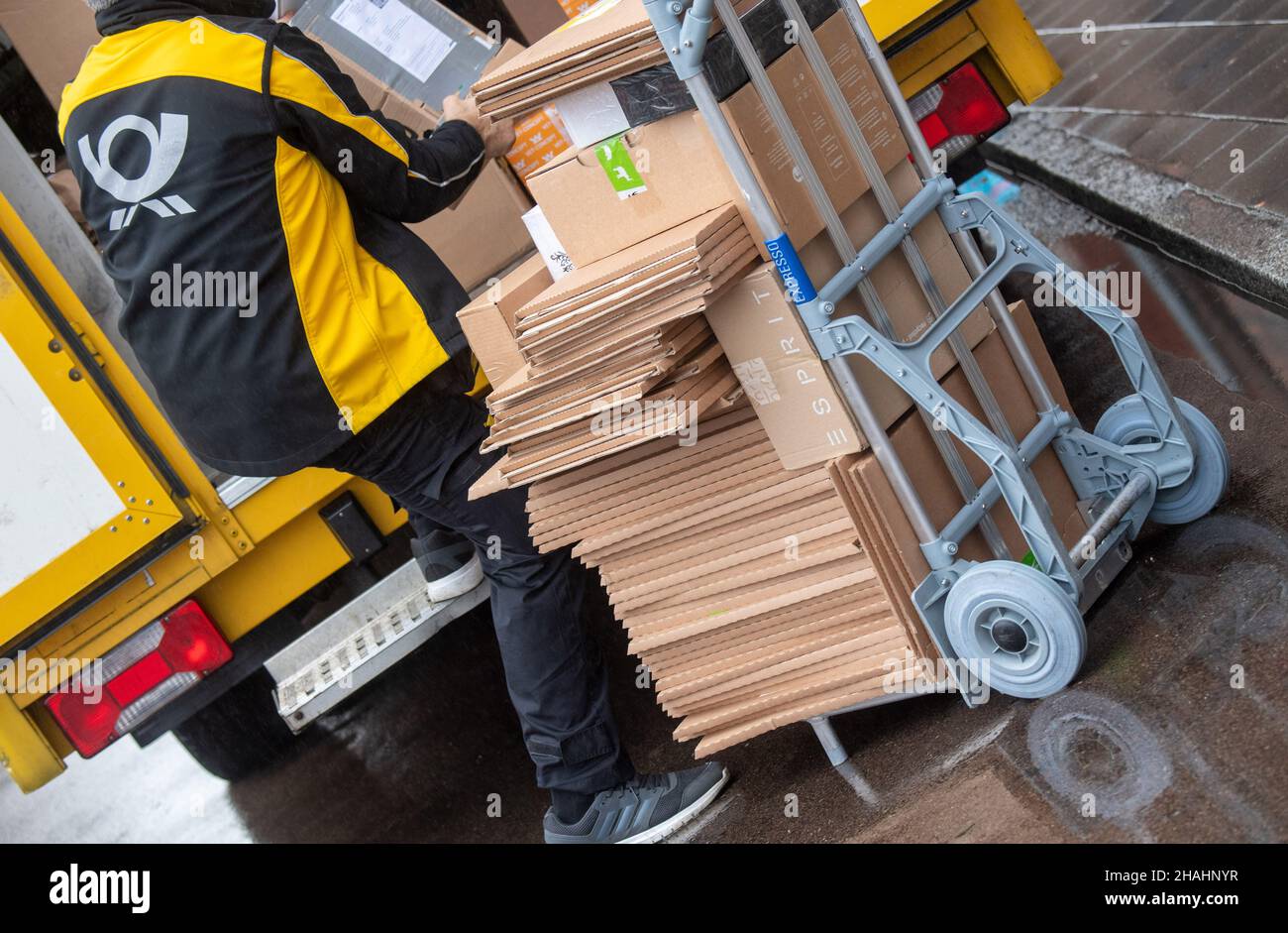 Stralsund, Germany. 13th Dec, 2021. A Deutsche Post parcel carrier ...