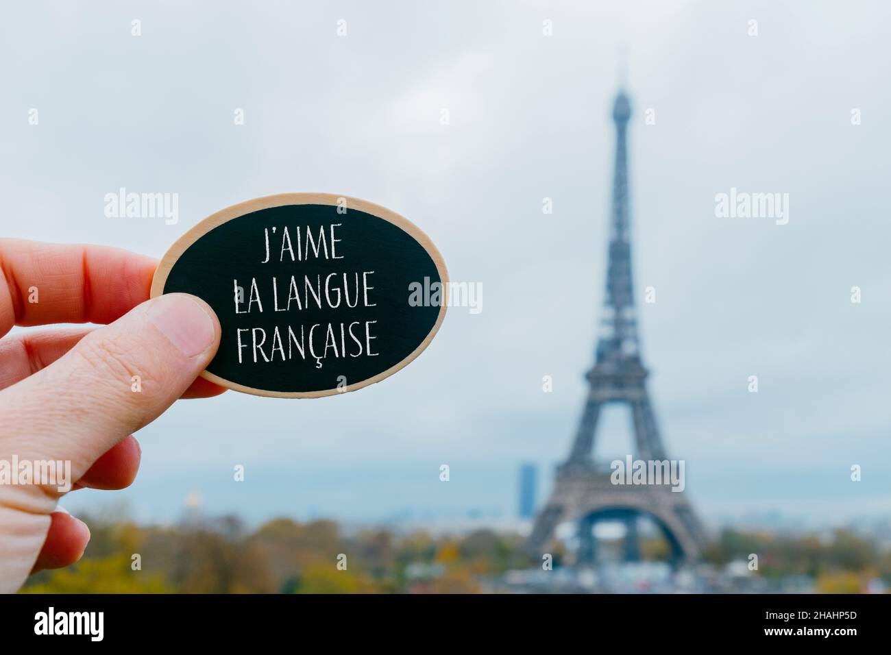 closeup of a young man holding a black signboard with the text text I ...