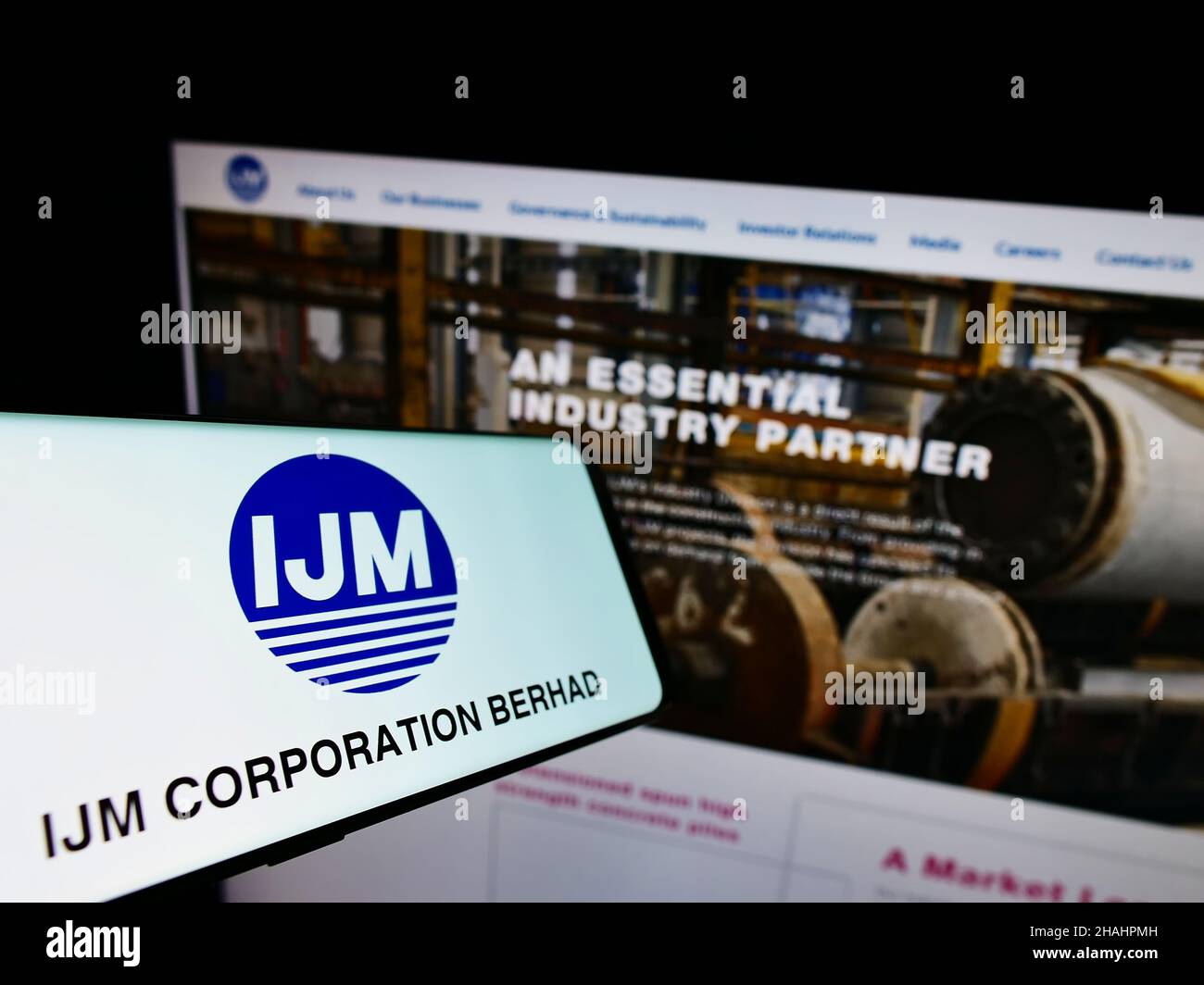 Cellphone with logo of Malaysian conglomerate IJM Corporation Berhad on ...