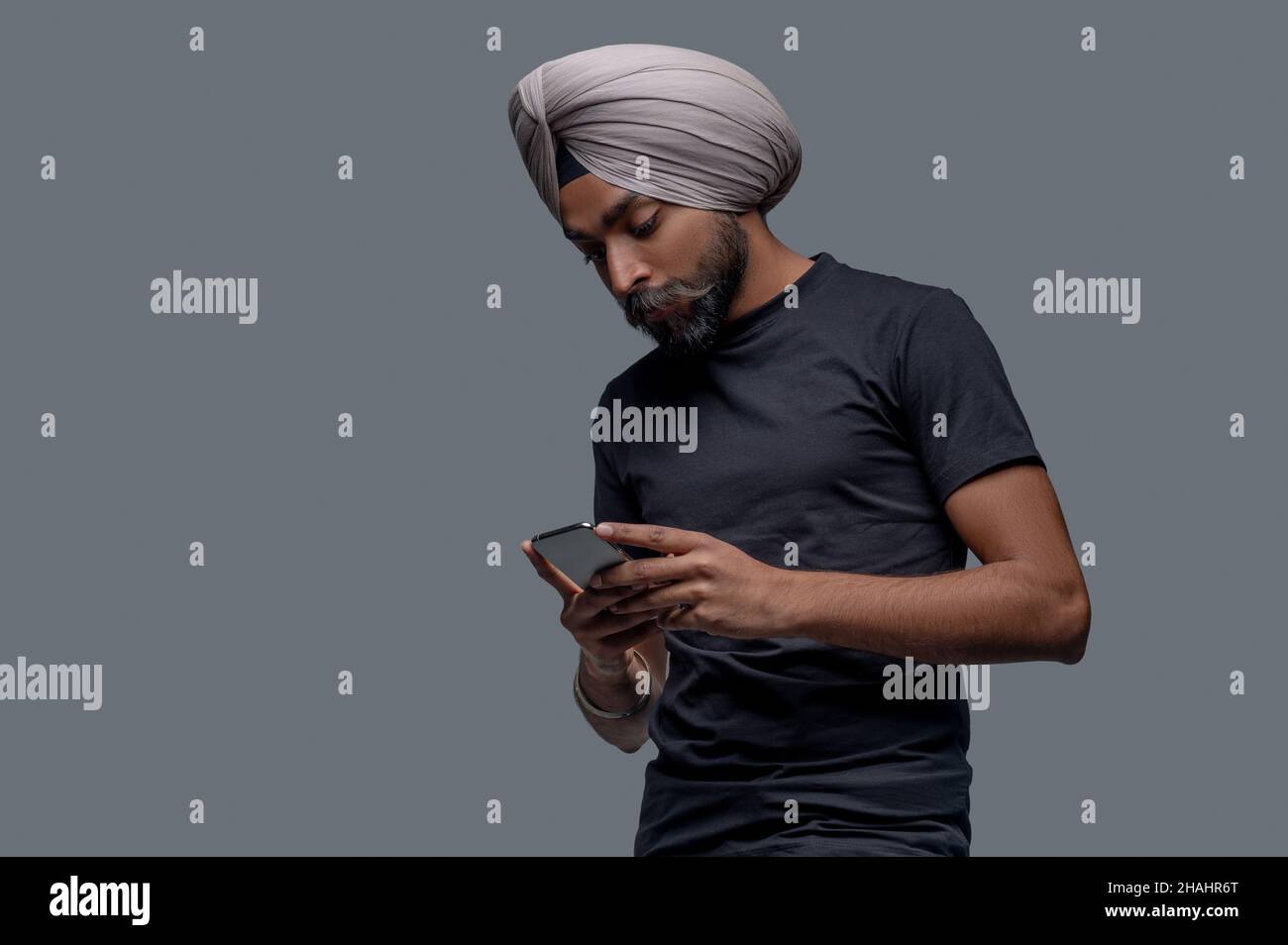Male staring at the cellphone in his hands Stock Photo - Alamy