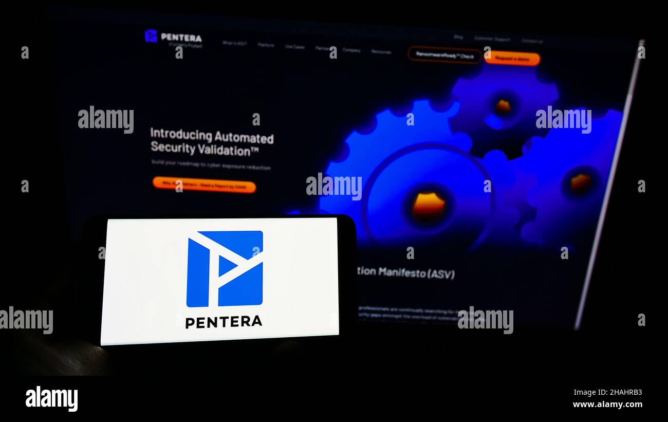 Person holding cellphone with logo of Israeli cybersecurity company ...