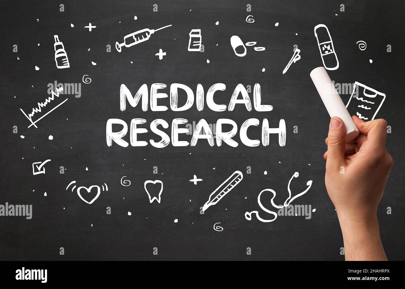 Hand drawing MEDICAL RESEARCH inscription with white chalk on ...