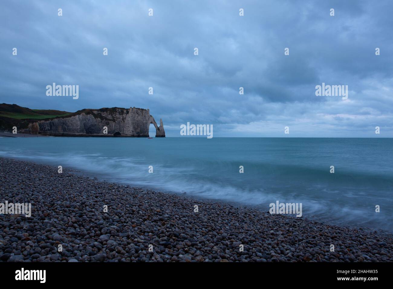 Very early morning on the beach in Etretat. Etretat is a charming town ...