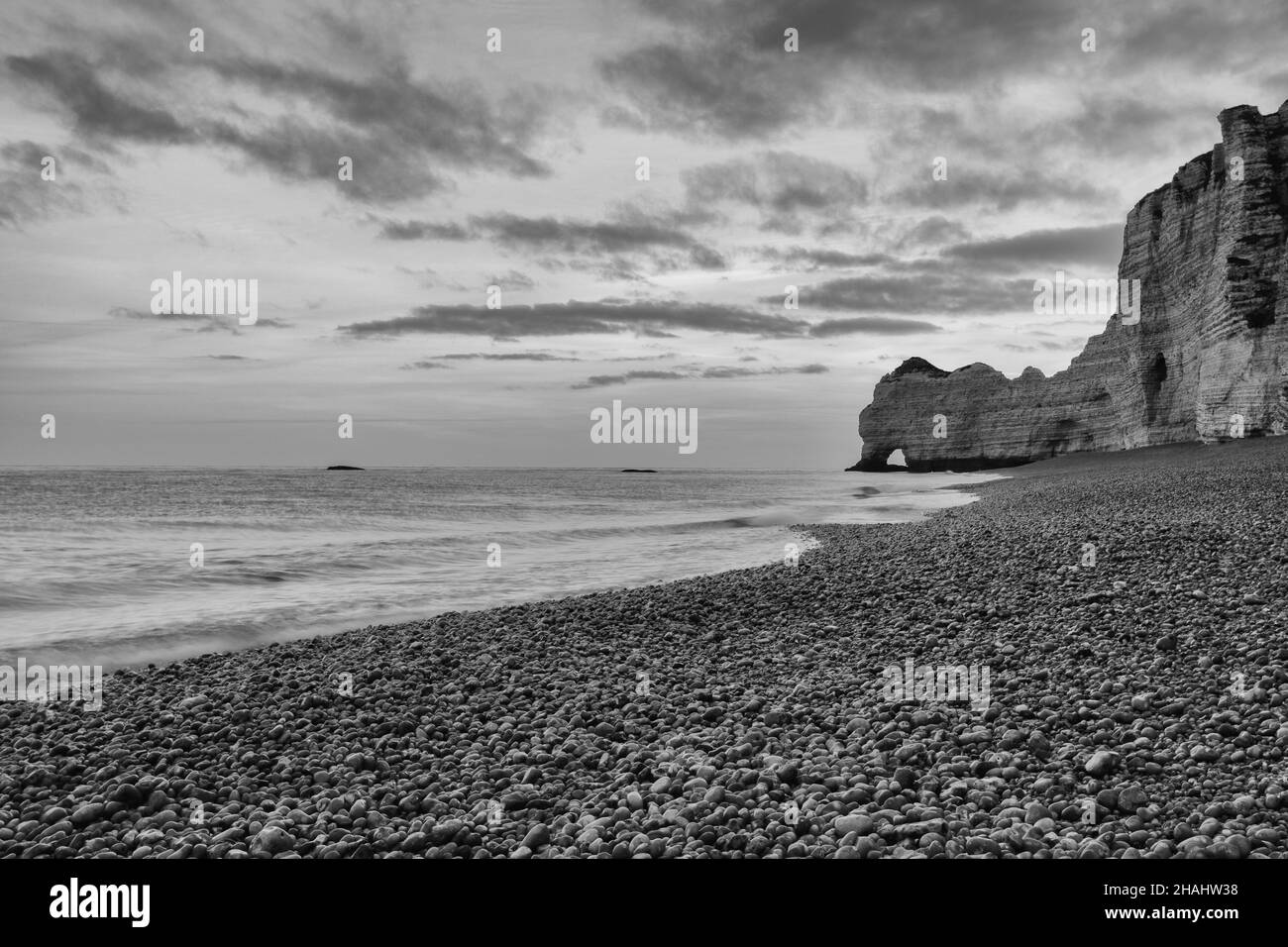 Very early morning on the beach in Etretat. Etretat is a charming town ...