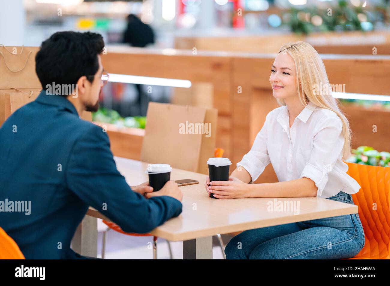 Happy handsome bearded man and attractive blonde woman having date ...