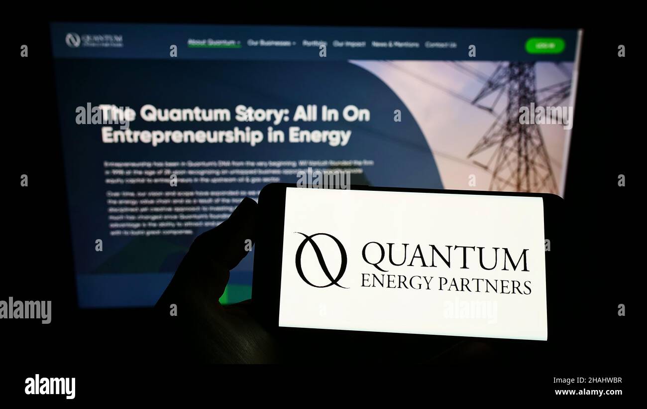 Person holding smartphone with logo of US private equity company ...