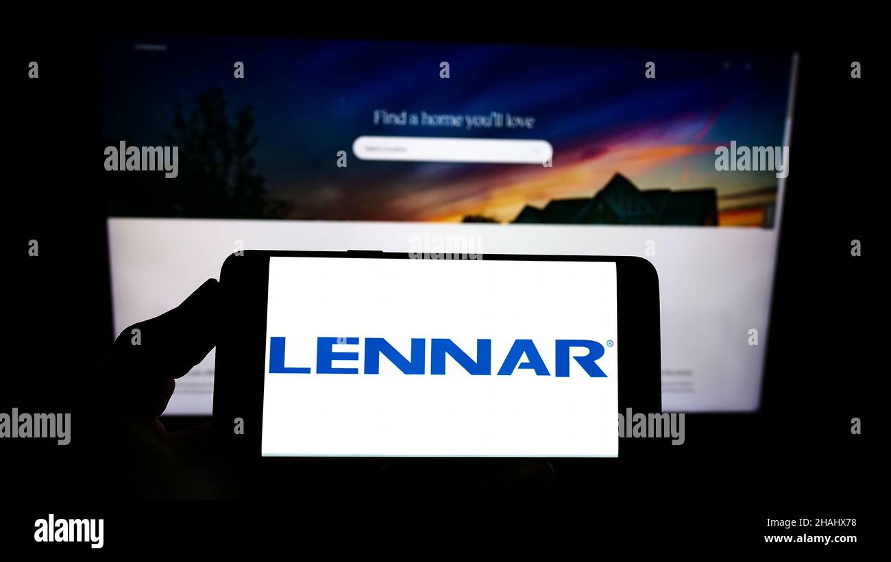 Person holding smartphone with logo of US home construction company ...