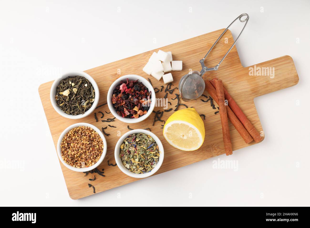 Concept of cooking tea with different types of tea on white background ...