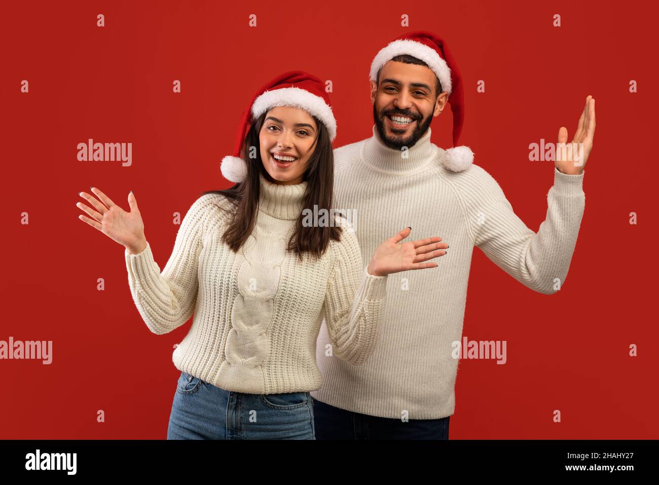 Christmas joy. Middle eastern couple in Santa hats celebrating winter ...
