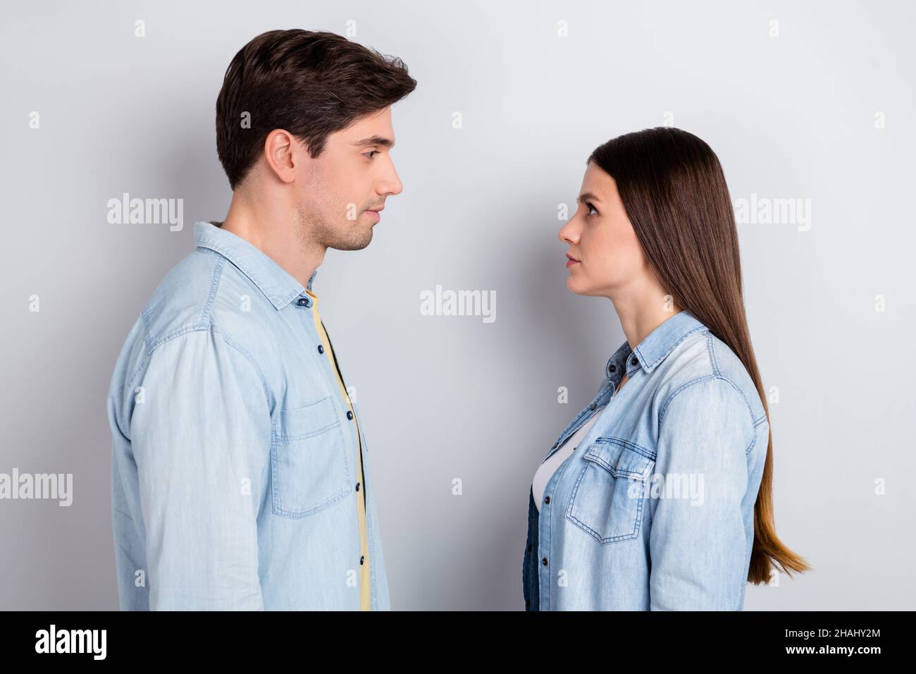 Photo of serious confident brother sister wear jeans shirts looking ...