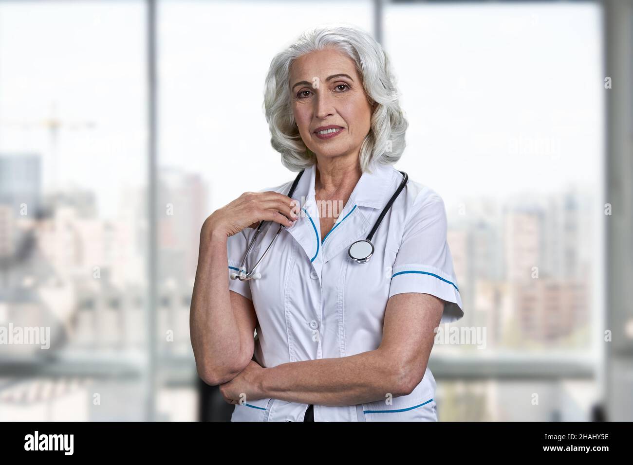 Portrait of pretty senior female doctor with stethoscope on window background Stock Photo - Alamy