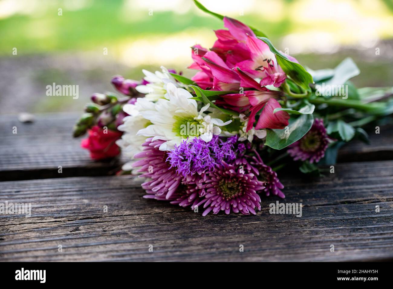 Bouquet of flowers on a bench Stock Photo - Alamy