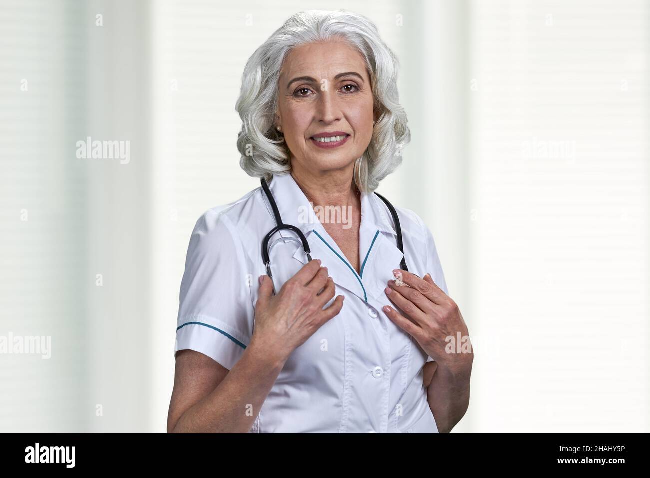 Pretty senior woman doctor with stethoscope looking at camera Stock ...