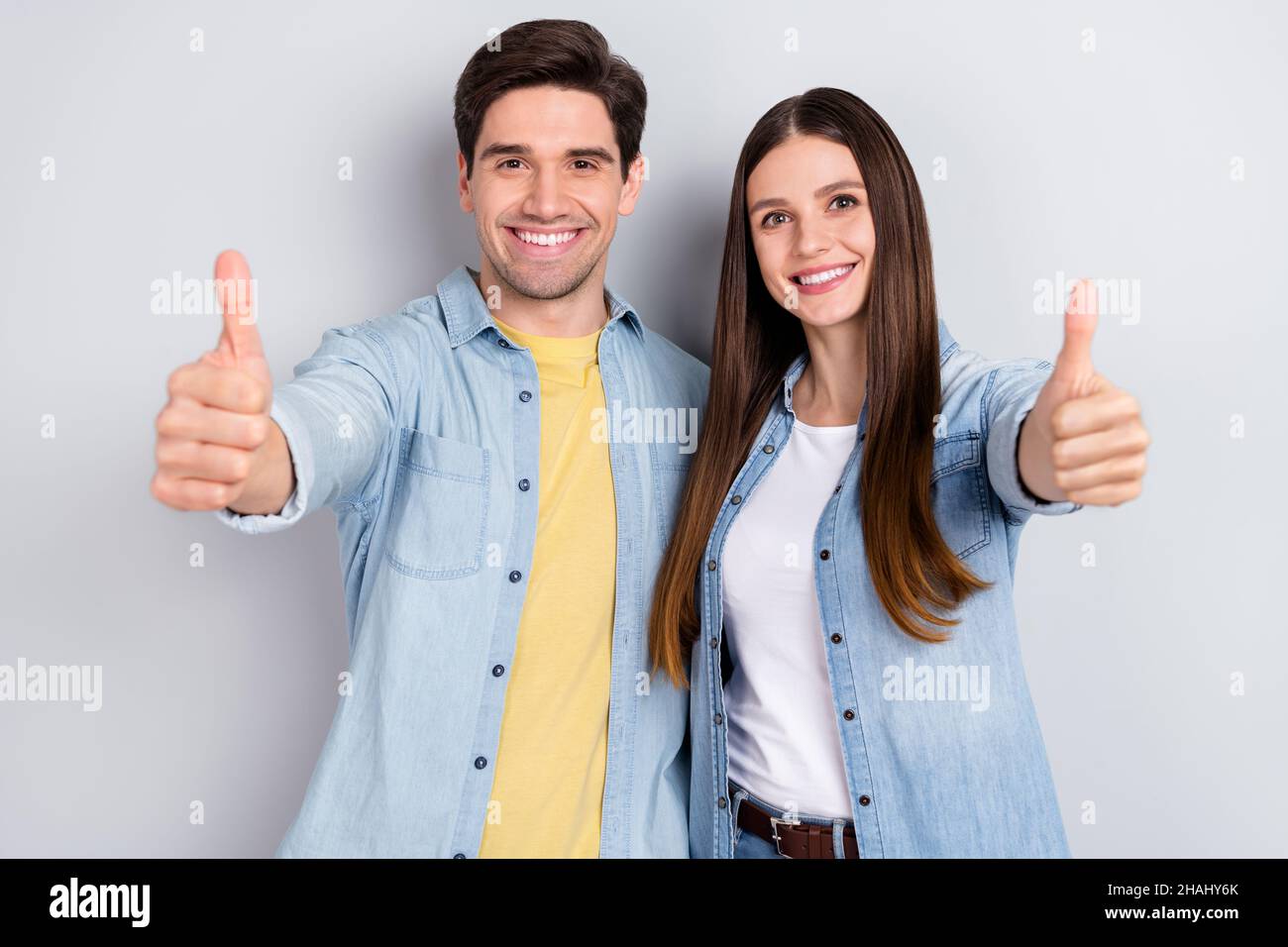 Photo of confident cute brother sister wear jeans shirts showing two ...