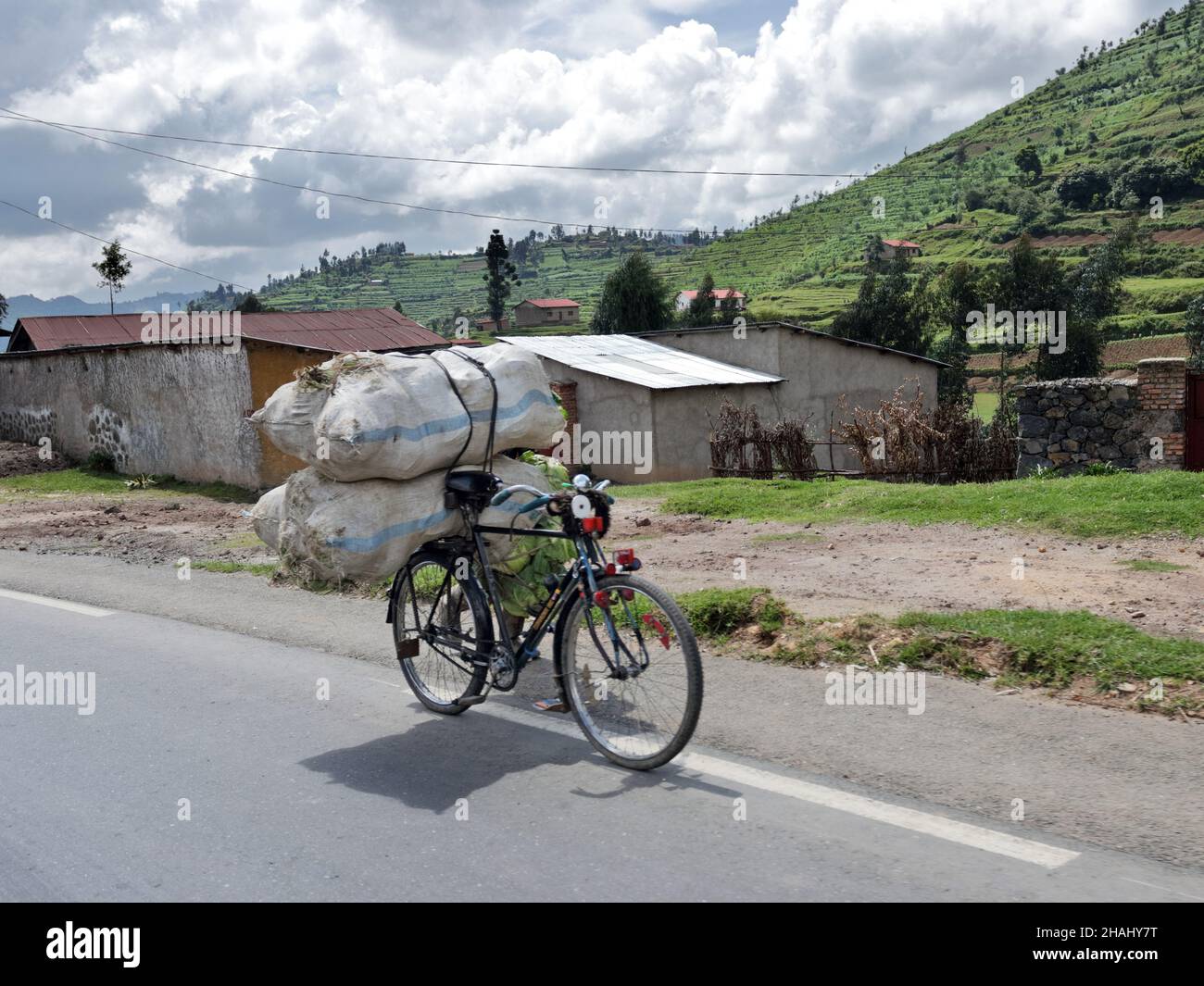 MUSANZE, RWANDA - Nov 16, 2018: people transporting heavy loads on a ...
