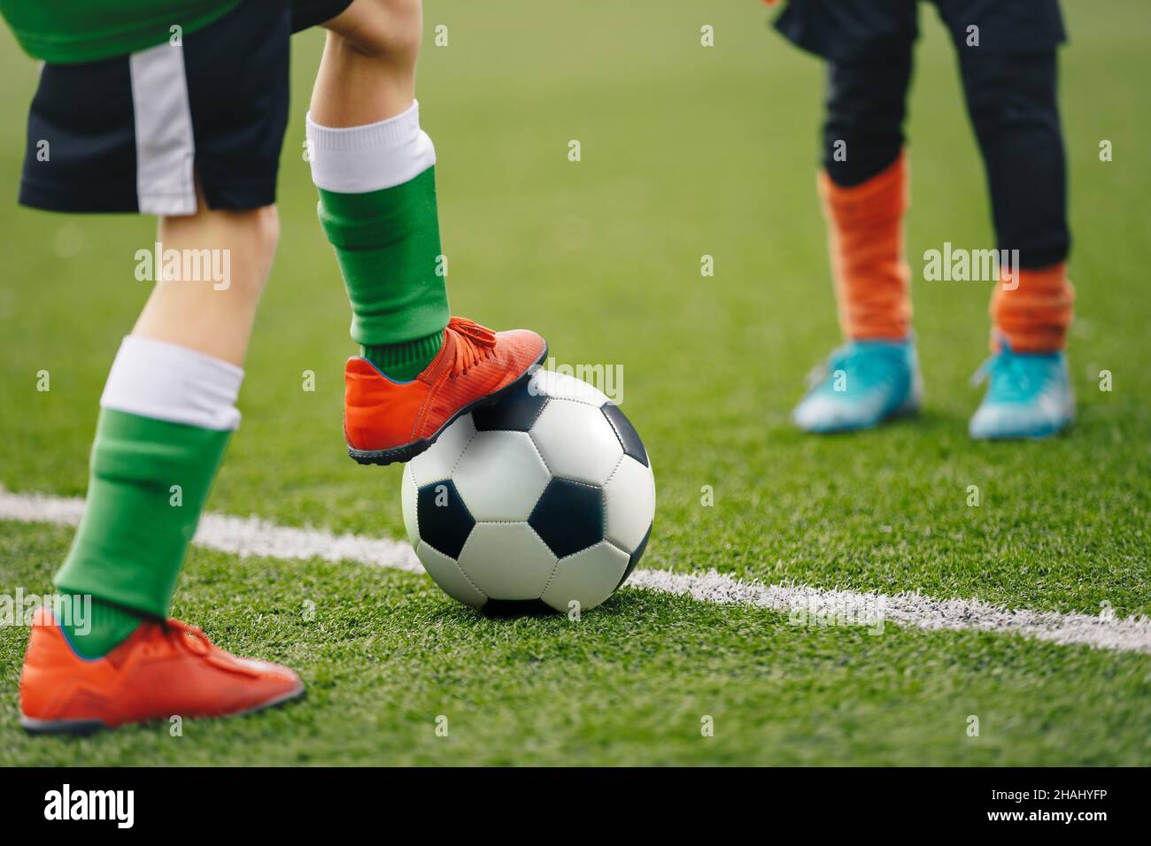 The close-up image on soccer player legs with the classic ball ...
