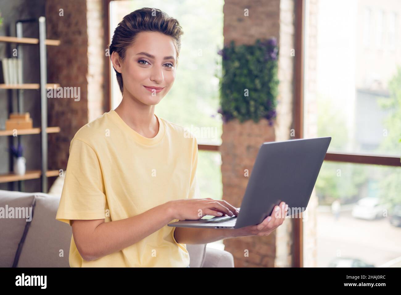 Photo of charming cute lady hold computer hand keyboard smile wear ...