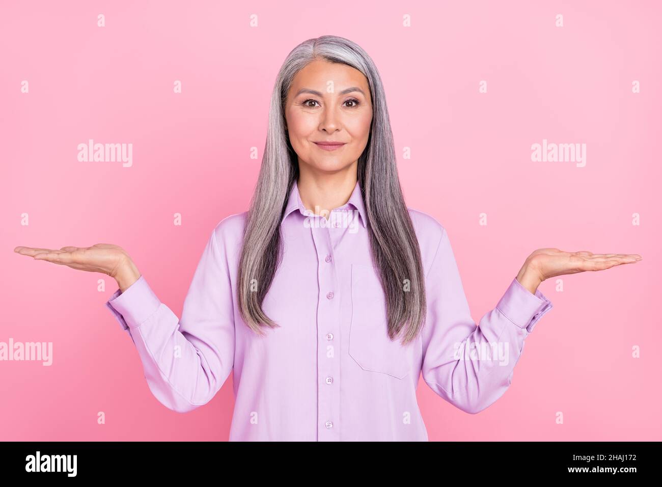 Portrait of attractive cheery confident gray-haired woman holding on ...
