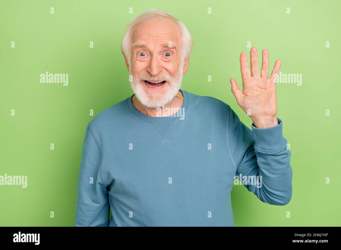 Photo of impressed aged beard man wave wear blue sweater isolated on ...